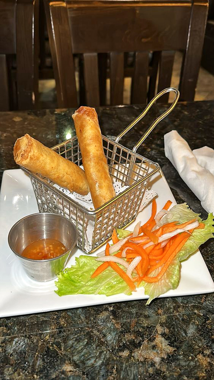 Golden-fried spring rolls that shatter with each bite, served in a miniature fry basket that's almost too cute to disturb. Almost.