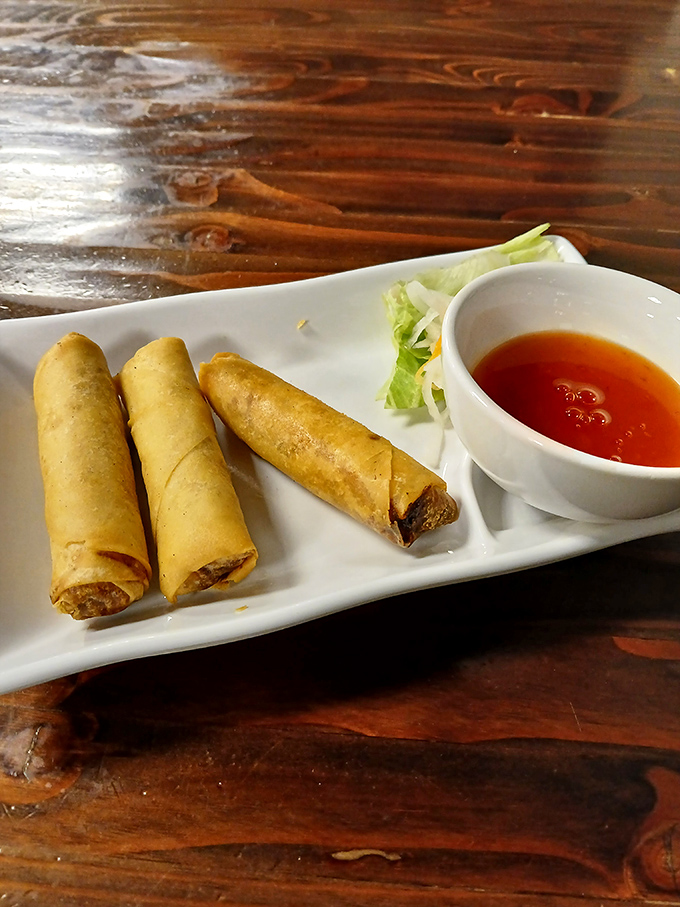 Spring rolls standing at attention like delicious little soldiers, crispy armor protecting the savory treasures within. Your taste buds salute them.