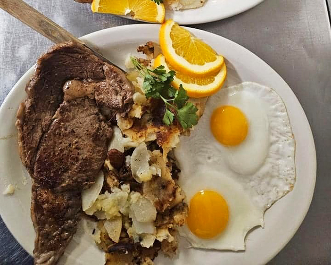 The breakfast trifecta&mdash;perfectly seared steak, sunny-side-up eggs, and crispy potatoes create the kind of plate that makes you seriously reconsider brunch reservations elsewhere.