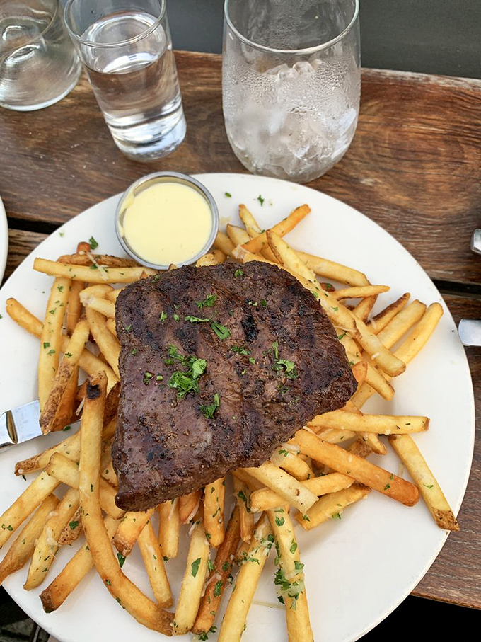 When a steak gets this comfortable with a pile of crispy fries, who are we to separate them? A match made in heaven.