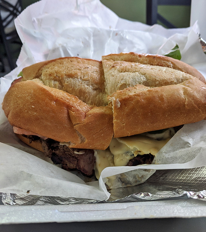 This isn't just a sandwich; it's architecture. Layers of thinly-sliced beef and melted cheese creating the Taj Mahal of lunch options.