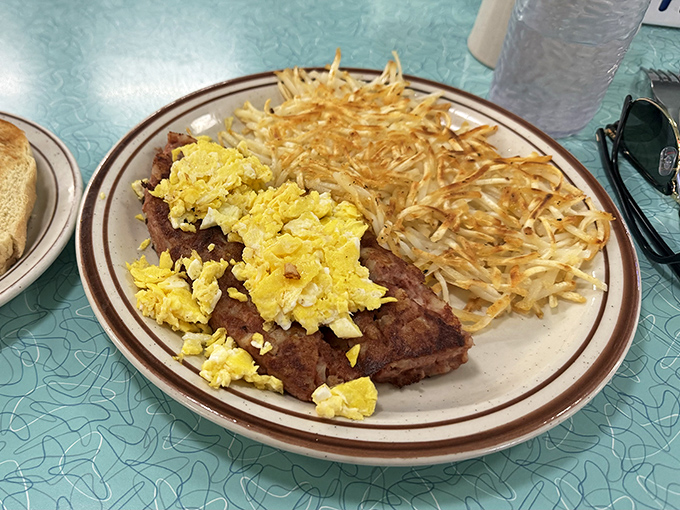 Breakfast of champions: perfectly seasoned steak tips topped with scrambled eggs alongside hash browns that achieved the impossible &ndash; both crispy and tender.