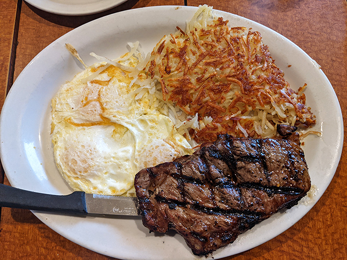 Breakfast of champions: a perfectly grilled steak alongside golden hash browns and eggs so sunny they could brighten even Monday mornings.