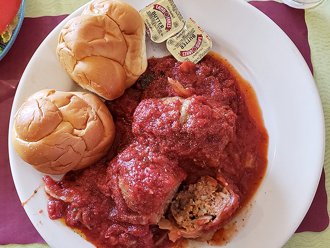 These stuffed cabbage rolls swimming in tangy tomato sauce aren't just food—they're edible history. The kaiser rolls stand by, ready for sauce-sopping duty.