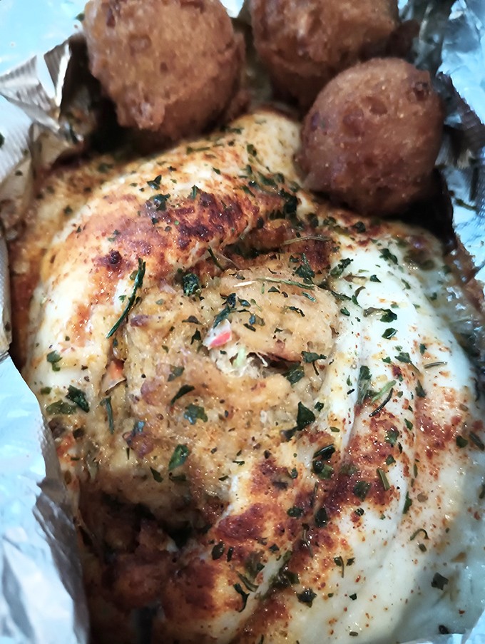 This stuffed flounder isn't just dinner&mdash;it's a seafood love letter from the Chesapeake, accompanied by hush puppies that deserve their own fan club.