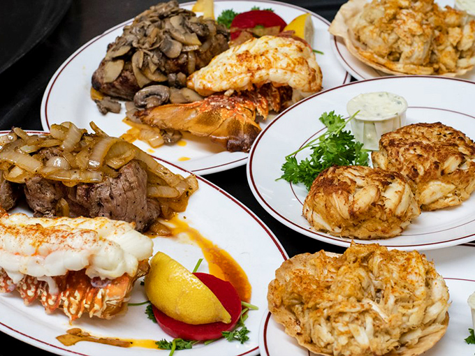 When choosing between surf and turf becomes unnecessary—crab cakes, lobster tails, and steak living in perfect harmony together.