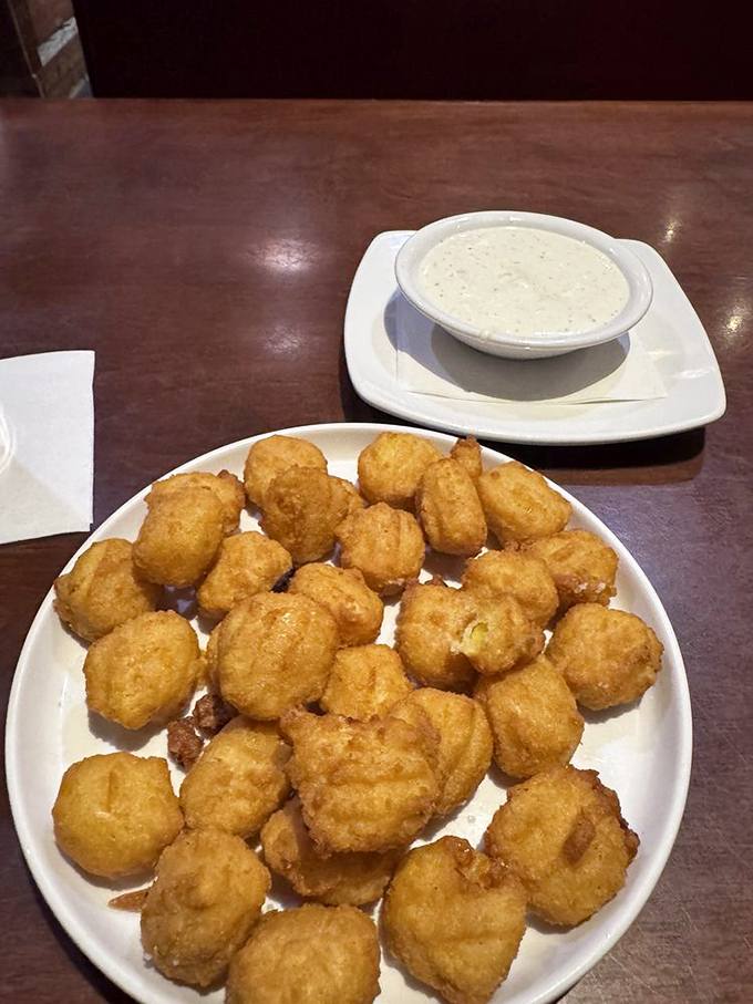 Golden-fried sweet corn nuggets with creamy dipping sauce&mdash;proof that sometimes the best supporting actors steal the show from the main course.