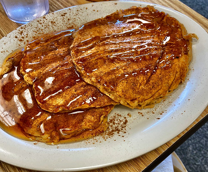 Pancakes so golden and syrup-soaked they make you question why we don't just start every conversation with "Would you like pancakes?"