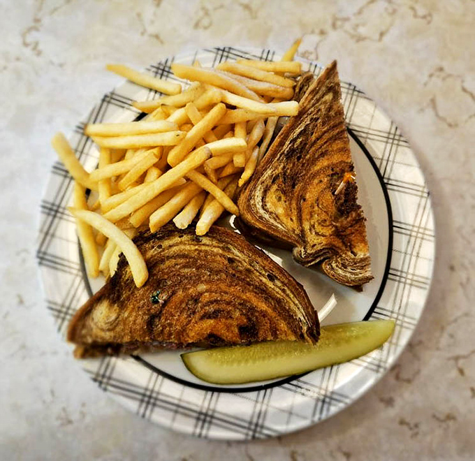 The perfect diner patty melt &ndash; where marbled rye, melted cheese, and beef unite in a harmonious trinity that makes you forget salads exist.