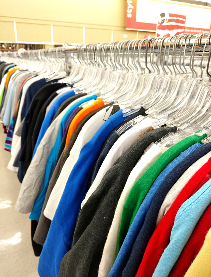 A rainbow of t-shirts tells tales of vacations taken, concerts attended, and corporate team-building exercises that someone desperately wanted to forget.