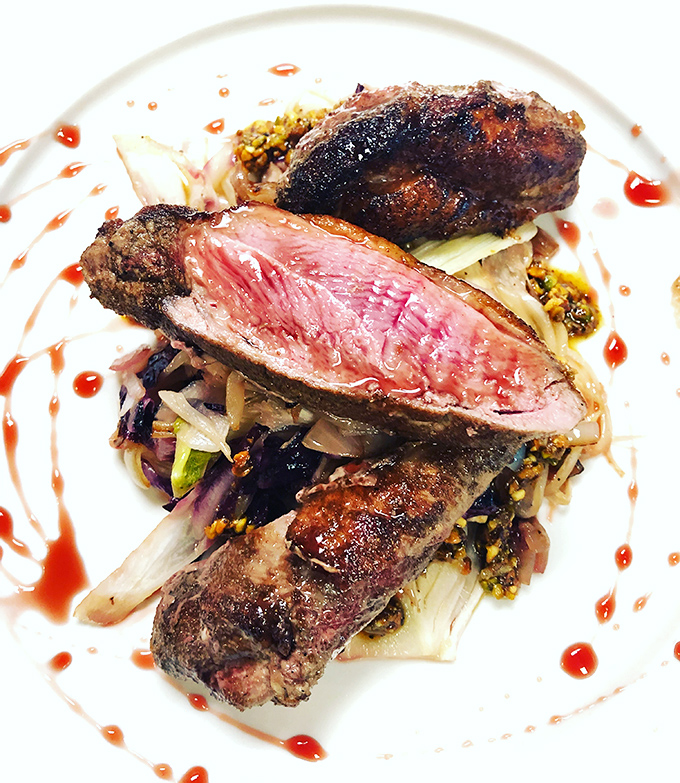 Duck breast that's pinker than a flamingo's blush, artfully arranged like edible modern art on your plate.