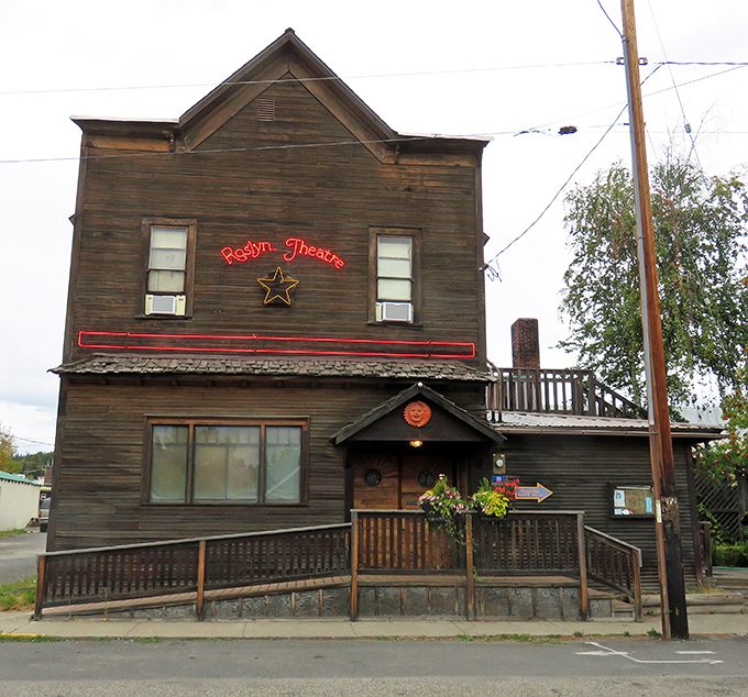 The Roslyn Theatre's vintage facade and glowing neon sign promise movie magic the way it was meant to be experienced.