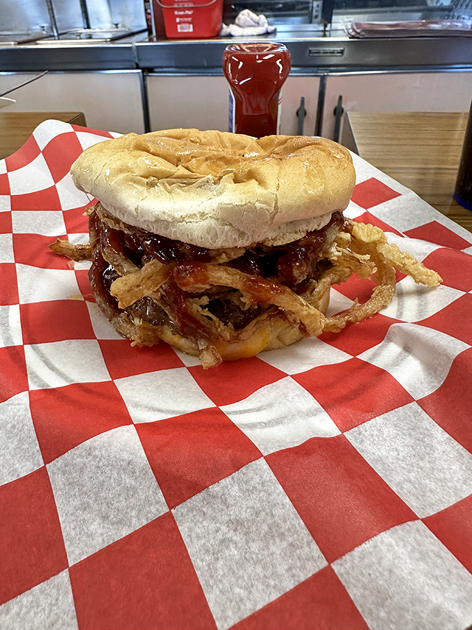 The Theta Burger with its crown of crispy onion strings&mdash;like a burger that graduated with honors and is showing off its achievement with delicious flair.