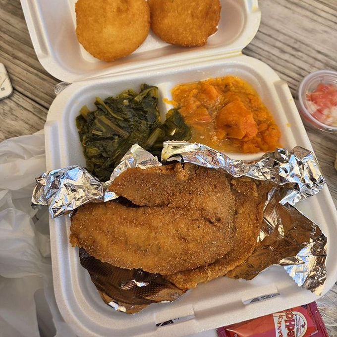 This fried fish with greens and sweet potatoes isn't just a meal&mdash;it's a Southern symphony on a styrofoam stage.
