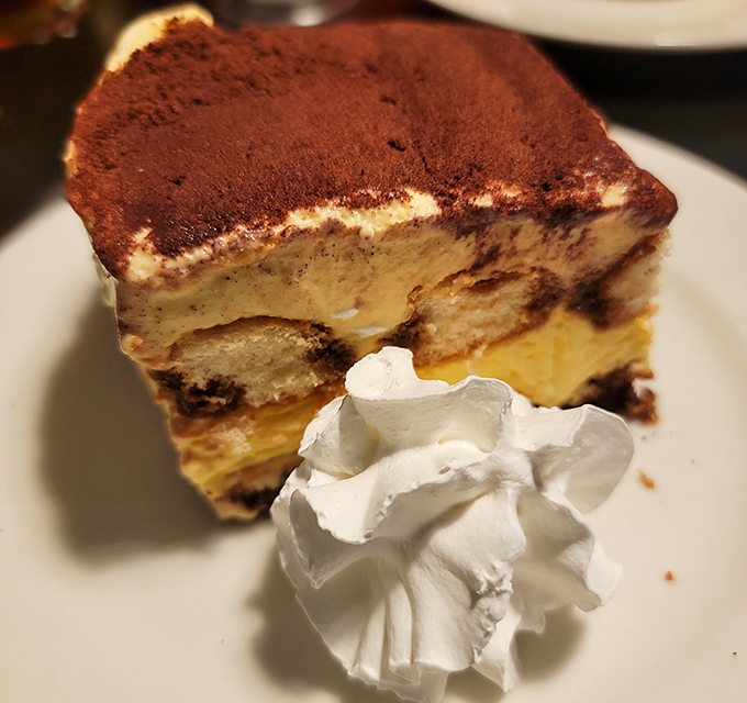 Tiramisu so perfectly layered it deserves its own architectural award. That dollop of whipped cream is the cherry on top.