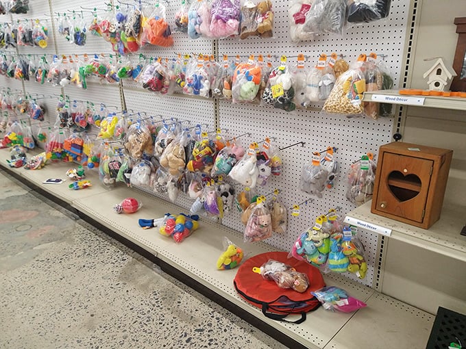 Bagged treasures hang like colorful fruit, each plastic pouch containing a surprise collection of toys awaiting their second chance at playtime.