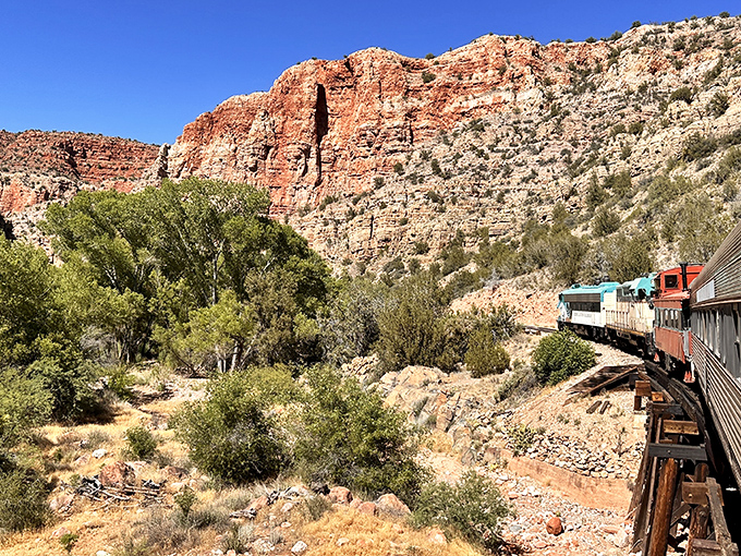 The train hugs curves that follow ancient pathways, where every bend reveals another postcard-worthy scene of Arizona's wild beauty.