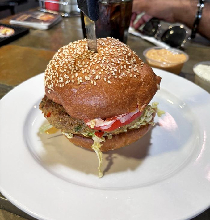 A turkey burger that doesn't taste like punishment. Sesame-studded bun cradles a patty that poultry dreams are made of.