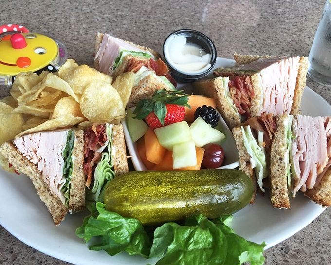 The club sandwich: where turkey, bacon, and fresh vegetables come together in a triangular masterpiece that makes lunch feel like a celebration.