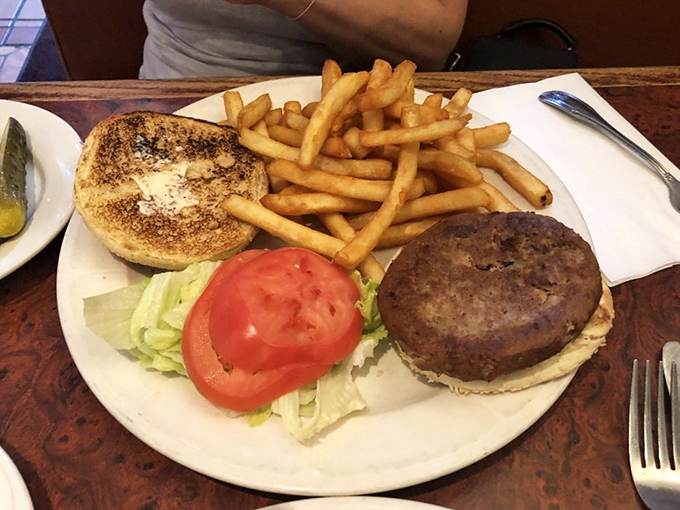 The classic burger and fries combo&mdash;where the tomato slice is perfectly centered as if positioned by a food stylist with OCD tendencies.
