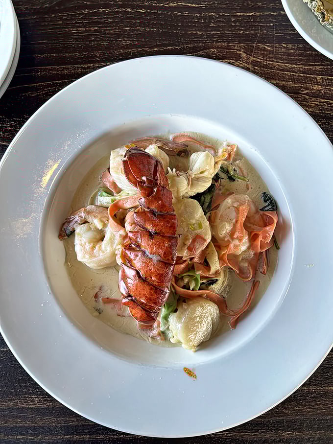 This seafood pasta isn't playing games – lobster tail standing proud among shrimp and scallops in a creamy sauce that whispers, "Diet? What diet?"