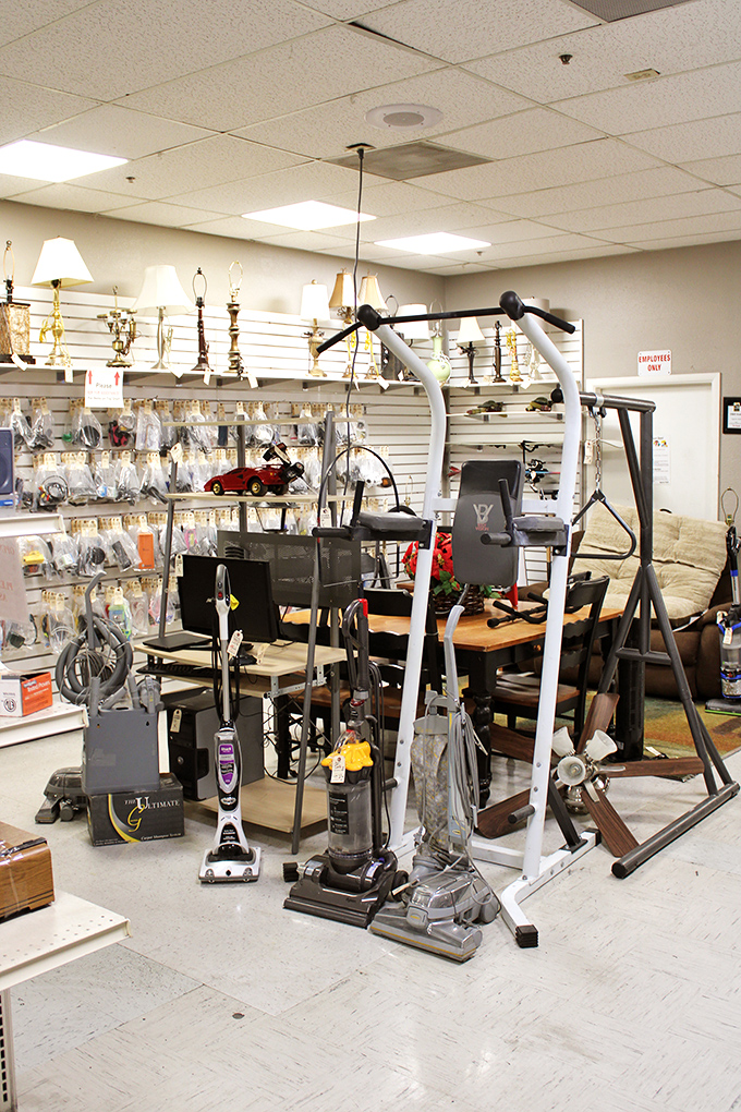 Exercise equipment and vacuums standing at attention, like hopeful contestants on a game show called "Take Me Home and Actually Use Me."