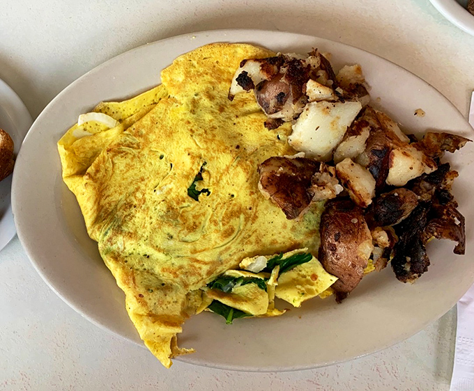 This isn't just an omelet&mdash;it's an edible love letter to breakfast. Folded with the precision of origami and paired with home fries that demand attention.