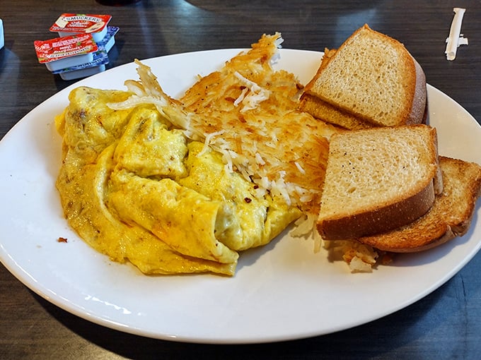 An omelet that respects eggs enough to treat them right, paired with hash browns that achieve that perfect crispy-outside, tender-inside balance. Breakfast harmony achieved.