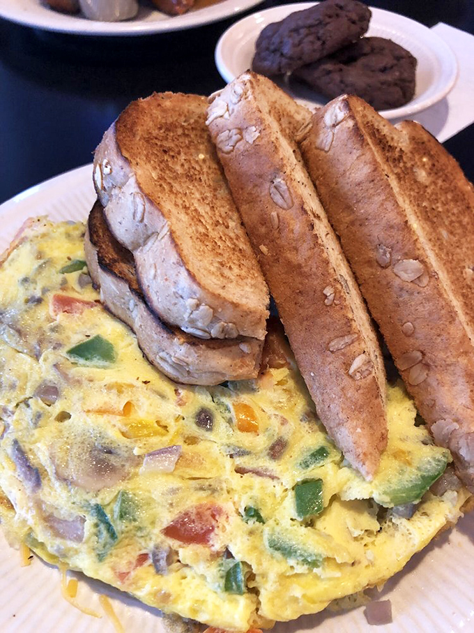 This veggie omelet packed with colorful peppers and served with hearty toast is what breakfast champions eat before conquering their day.