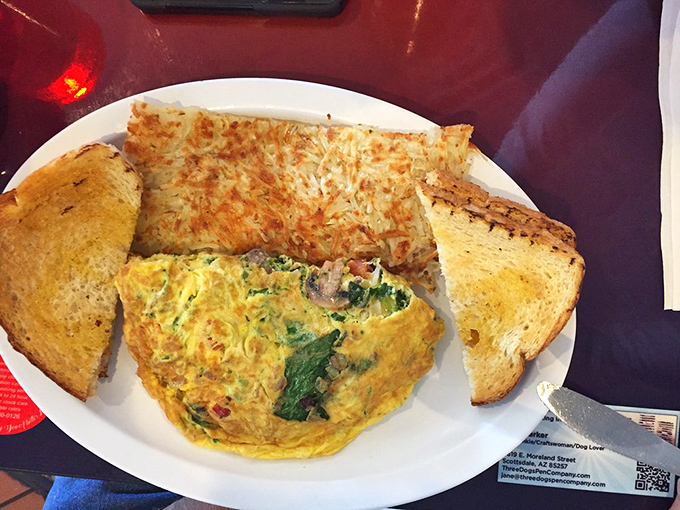 An omelet that actually remembered to invite vegetables to the party, paired with hash browns crisped to golden perfection.