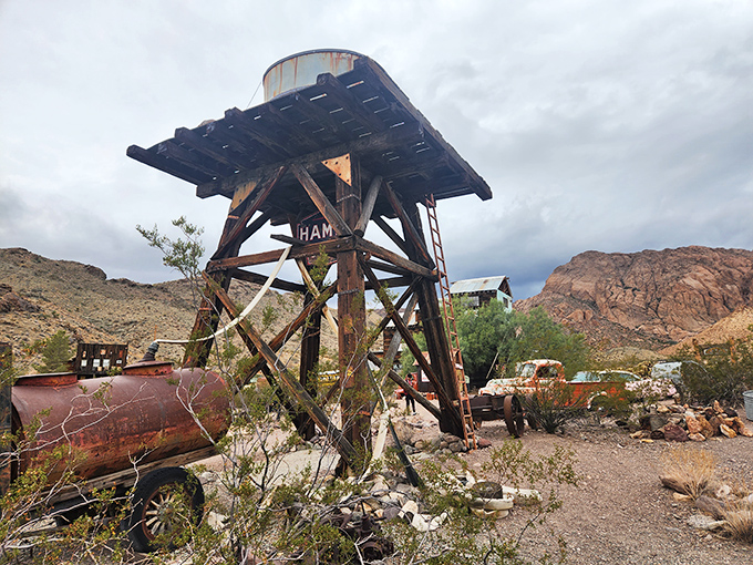 The water tower stands like a desert lighthouse, guiding ghost town visitors instead of ships. Whoever climbed this last probably had excellent health insurance.