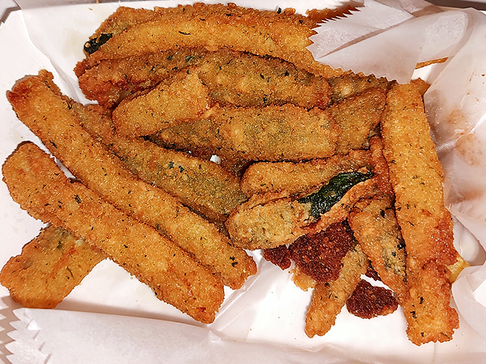 Zucchini fries that could convert vegetable skeptics. Crispy, herb-flecked exterior giving way to tender green goodness – side dish or main event?