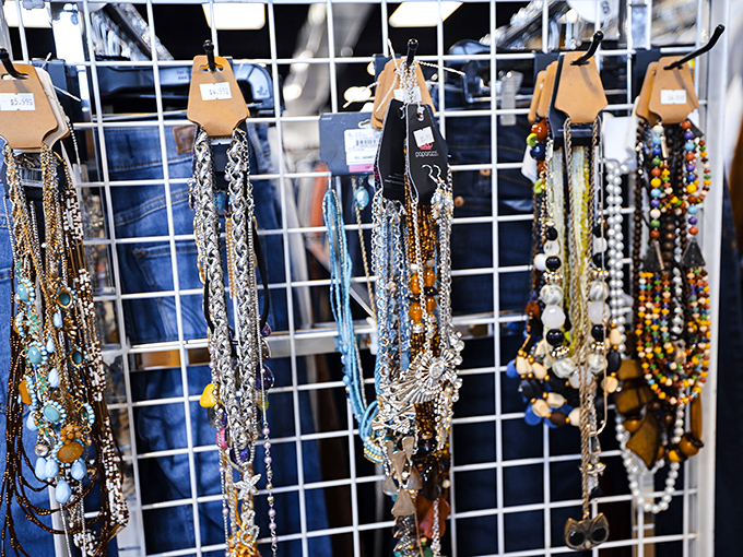 A rainbow of necklaces dangles with possibility. One person's forgotten accessory becomes another's statement piece&mdash;that's thrift store magic.