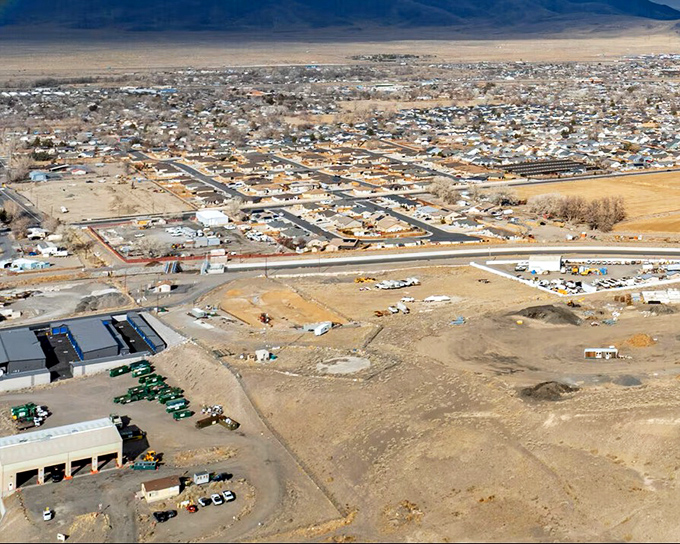 The big picture reveals Fernley's strategic desert valley location. Mountains embrace this affordable oasis like nature's own retirement plan.