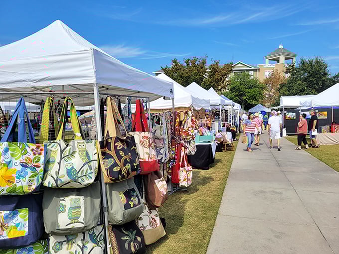Colorful vendor tents line the walkway during market days&mdash;where "just browsing" becomes "somehow I bought four handmade beach bags."