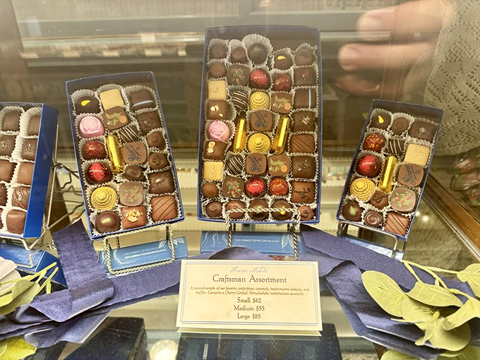 The chocolate assortment boxes are arranged with military precision but promise peace, not war. Each piece is a diplomatic mission of flavor waiting to be discovered.