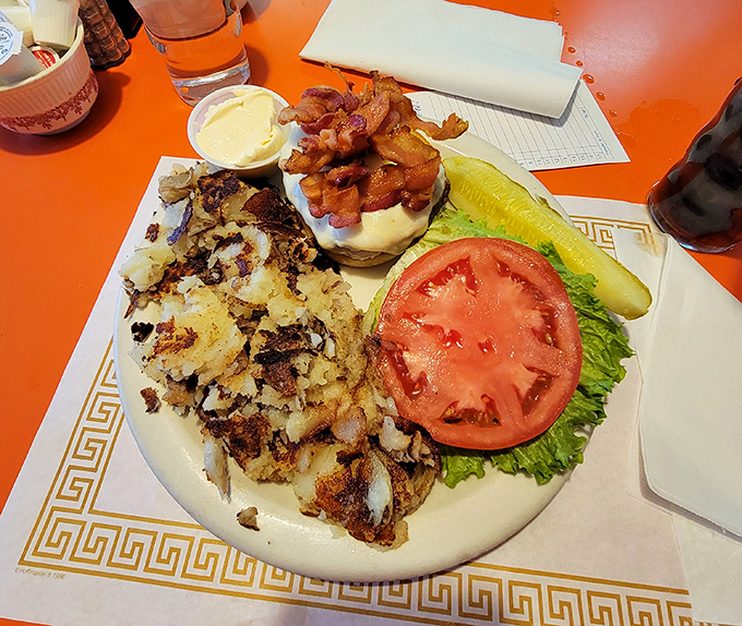 A burger that requires both hands and a strategy&mdash;crispy hash browns on the side aren't just accompaniments, they're accomplices in deliciousness.