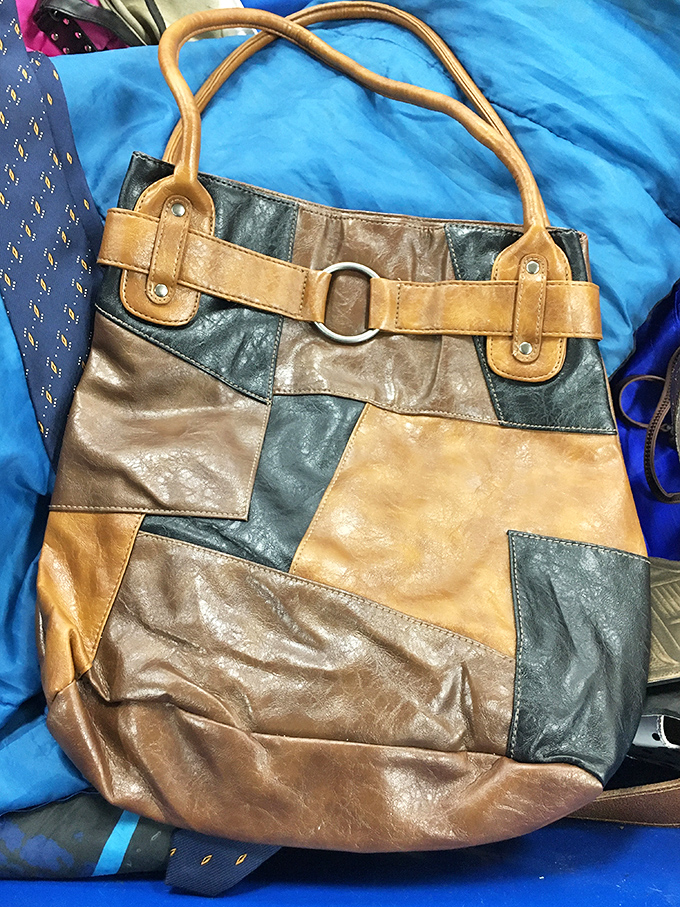 A patchwork leather handbag that tells stories of its own. Someone's fashion discard becomes another's signature accessory.