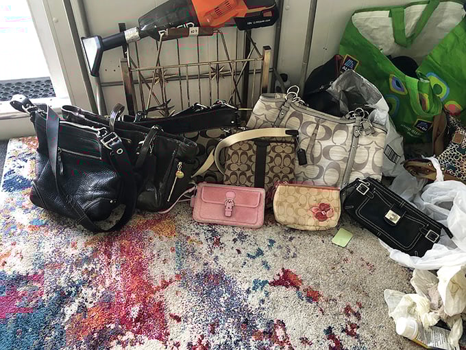 Designer purses mingle with everyday totes in democratic fashion. That Coach bag has seen better days, but it's ready for its second act.