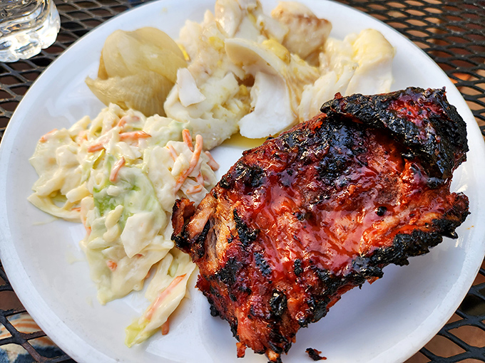 These ribs don't just fall off the bone—they practically jump onto your fork, their caramelized exterior hiding meat so tender it should require a love letter, not a knife.