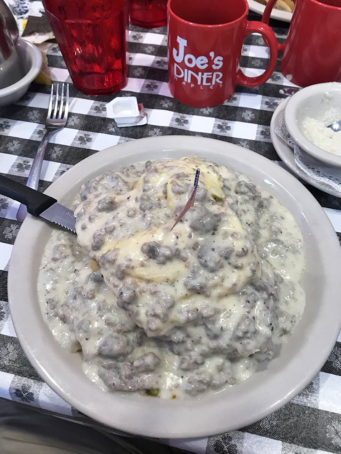 Behold the star attraction: biscuits drowning happily in a sea of peppery sausage gravy. That tiny American flag isn't patriotic&mdash;it's marking buried treasure.
