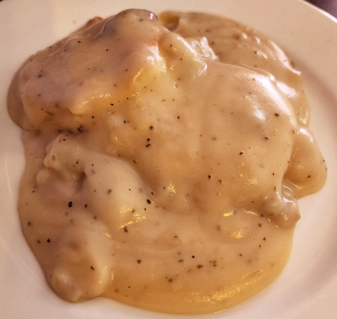 Biscuits smothered in peppery gravy—the breakfast equivalent of a warm hug from someone who genuinely wants you to have a good day.