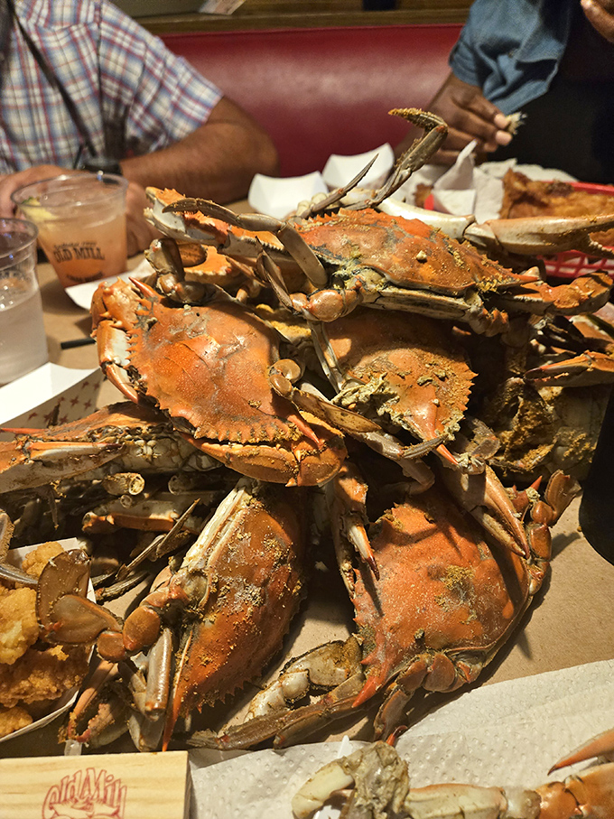 Blue crabs piled high on brown paper&mdash;this isn't just dinner, it's an event where the reward for your picking efforts is sweet, delicate meat.