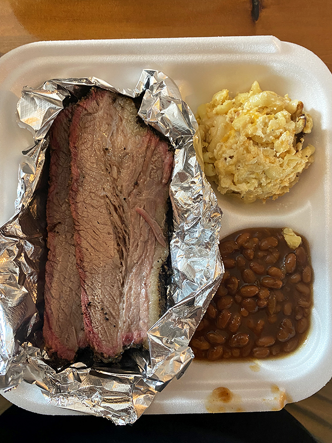 Brisket that's been kissed by smoke until it blushes pink. Paired with mac and cheese and beans, it's a trio that performs better than most rock bands.