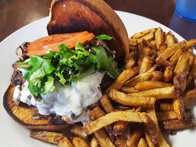 A burger that's been kissed by fire, accompanied by hand-cut fries that have achieved that mythical balance of crispy exterior and fluffy interior. This is comfort food elevated.