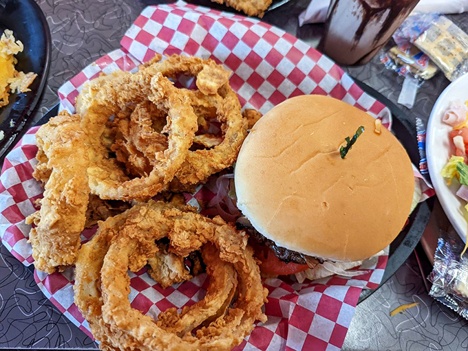 Those onion rings aren't just sides&mdash;they're main attractions with a burger chaperone. Crispy, golden, and unapologetically indulgent.