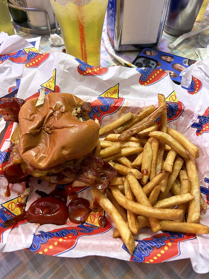 This burger's so photogenic it probably has its own Instagram account. Those fries look like they're auditioning for a supporting role in comfort food heaven.