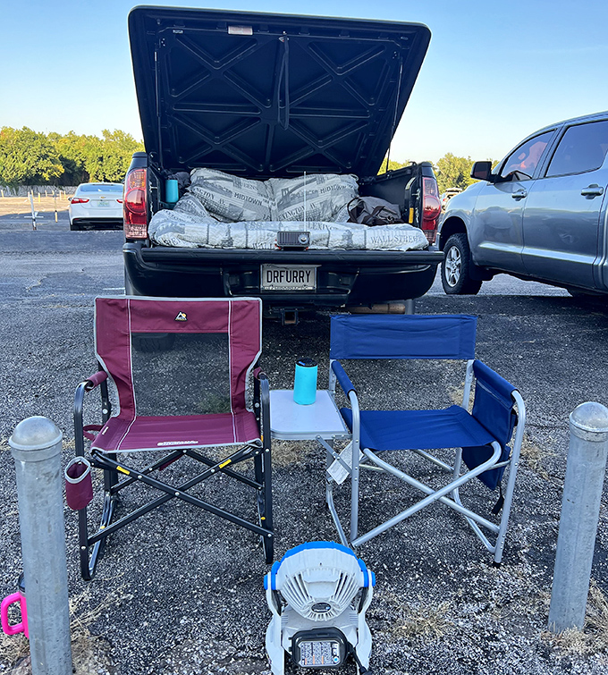 The drive-in pro setup: camp chairs positioned just so, truck bed transformed into a cozy nest, and not a streaming subscription in sight.