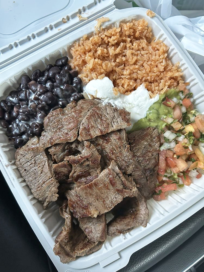 The carne asada plate isn't just a meal; it's a perfectly balanced composition where each element plays its essential role.