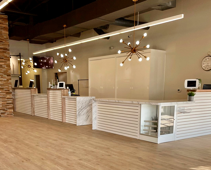 The checkout counter doubles as a fashion command center. Those mid-century modern light fixtures? They're not just illuminating transactions but elevating the entire experience.